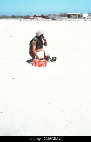 US Navy EOD team member dives into the water for an inspection of the ...