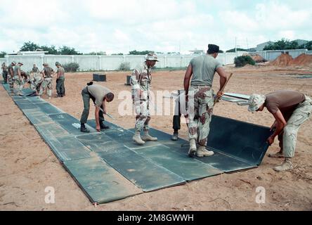 Marines and Seabees work together to build a helicopter landing pad at ...