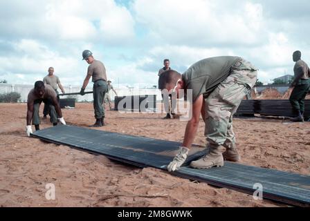 Marines and Seabees work together to build a helicopter landing at the ...