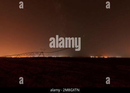 Irrigation system in field at night with the Milky Way in the fields of ...