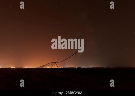 Irrigation system in field at night with the Milky Way in the fields of ...