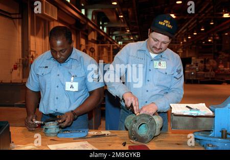 Boiler Technician Third Class (BT3) Steven Clouse reassembles the upper ...