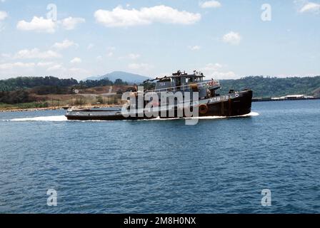 The large harbor tug Kalispell (YTB-784) moves toward the hospital ship ...