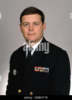 Rear Adm. (lower half) Thomas A. Mercer poses for photo with his family during the change of ...