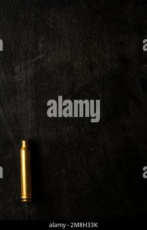 Empty rifle bullet cartridge lying on the black background Stock Photo ...