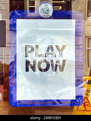 Play Now - UK National Lottery advertising sign outside retail premises ...