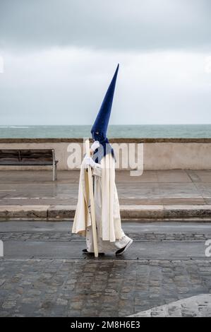 People in traditional dress weraing a capriote, or pointed hat in an ...