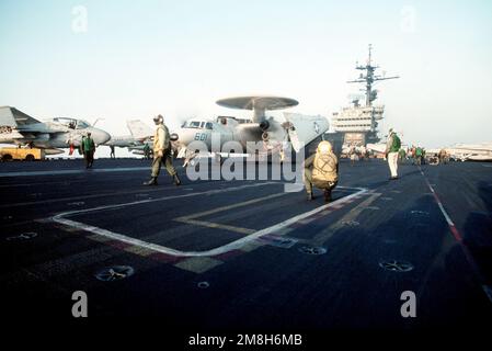 Catapult crew members prepare to launch an F-14A Tomcat aircraft from ...