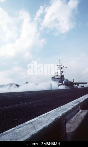 Catapult crew members prepare to launch an F-14A Tomcat aircraft from ...