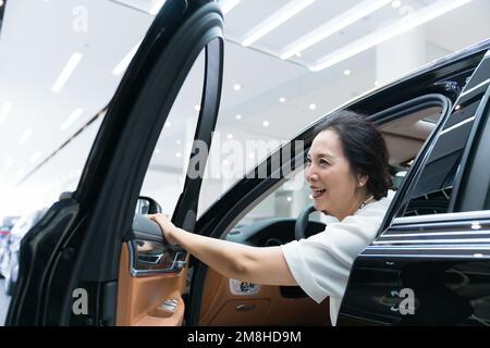 Elderly woman test drive cars Stock Photo - Alamy
