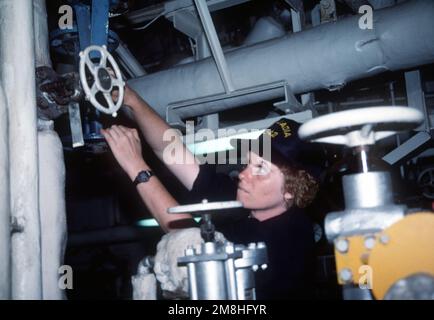 Boilerman Technician/Fireman Rebecca Powers turns a valve to maintain ...