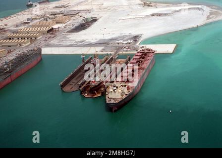 An aerial view of various ships and floating dry docks moored at the ...