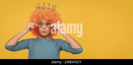 amazed teen child in crown on yellow background Stock Photo - Alamy