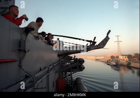 Crew members watch from the railing as the battleship USS MISSOURI (BB ...