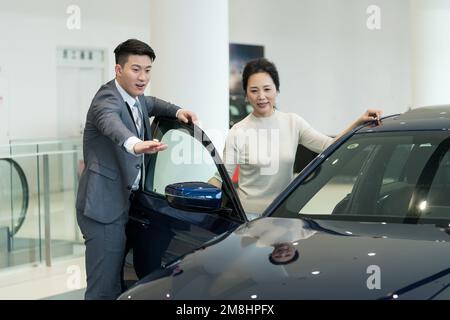 Older women choose and buy cars Stock Photo - Alamy