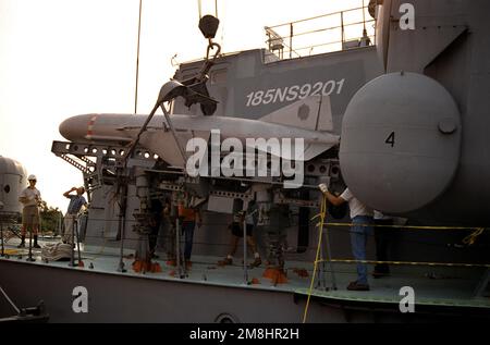 A P-15 SS-N-2c Styx SSM is unloaded from the No. 4 missile tube aboard ...
