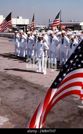 Crew members stand in formation at the start of the decommissioning ...
