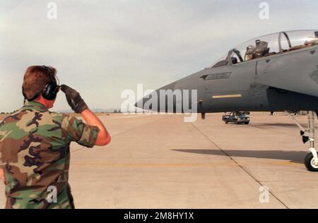 A close up of 1ST LT. Jeannie Flynn, the first F-15E female pilot, sits ...