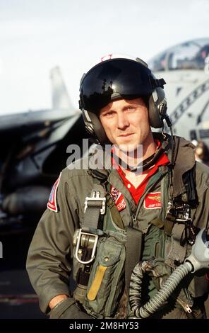 An F-14 Tomcat pilot of Fighter Squadron 102 (VF-102) waits in the ...