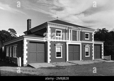 A restored vintage carriage house against a dramatic sky at the Codman ...