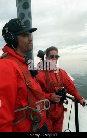 Storekeeper Second Class (SK2) David Stewart stands the phone watch on ...