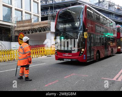 Banksman traffic marshall with fluorescent suit and helmet with stop ...