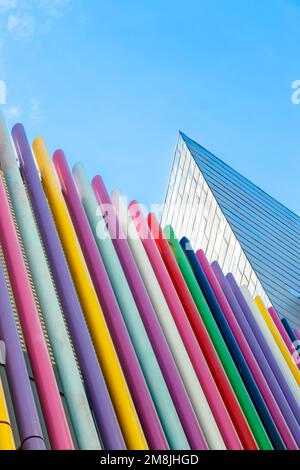 abstract looking up at colourful stripy pipes on the facade of costa ...
