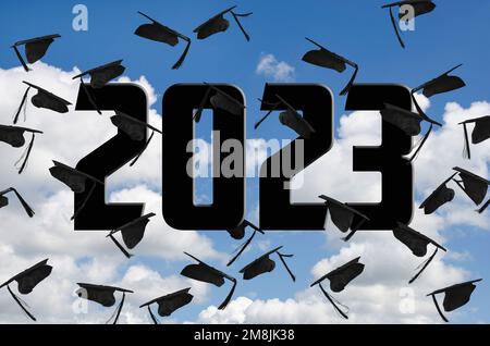 Airborne black 2023 graduation caps in the sky with a rainbow Stock ...