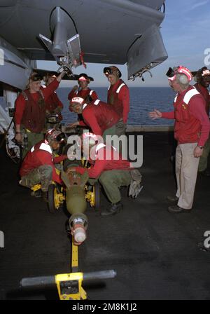Aviation ordnancemen from Attack Squadron 46 (VA-46) lift a Mark 82 500 ...