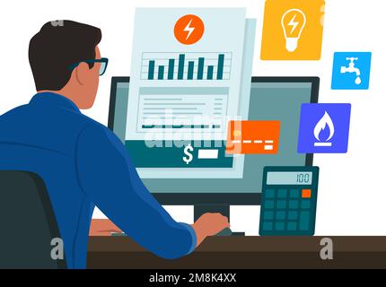 Man sitting at desk and paying his utility bills online on his computer ...