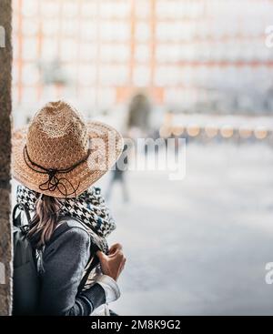 Back view of woman wearing hat at beach at Bournemouth, Dorset UK in ...