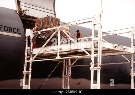 Unloading cargo from a U.S. Army Air Transport Command cargo plane ...
