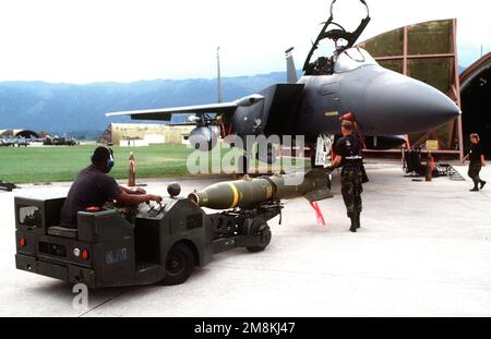 Weapons loaders from the 555th Fighter Squadron load a laser guided ...
