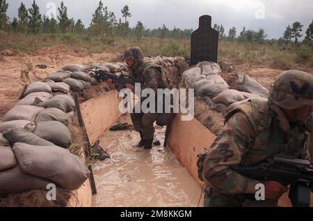 Members of the 24th Infantry Division (Mechanized) observe an M1 tank ...