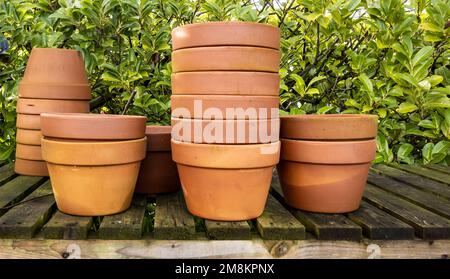 Stacks of various terracotta pots for plants for sale at a garden store ...