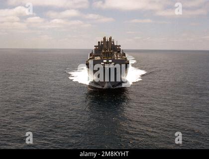 An aerial low oblique bow-on view of the guided missile destroyer USS ...