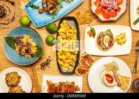 A top view of Spanish tapas with dishes on a wooden table Stock Photo ...