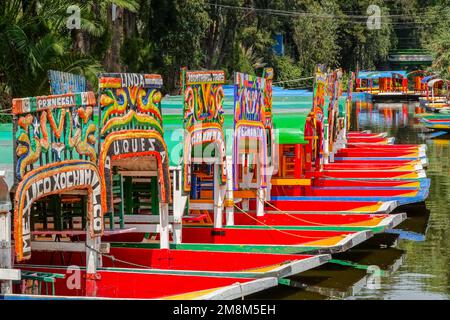 Colorful painted trajinera boats waiting for tourists to travel the ...