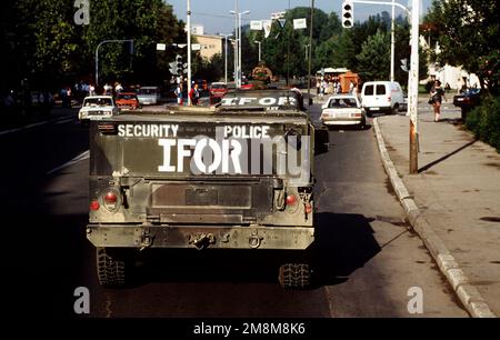 Implementation Force (IFOR) vehicles in a holding area at Taszar Air ...