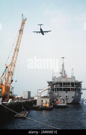 A stern view of the submarine tender USS L.Y. Spear (AS-36) tied up at ...