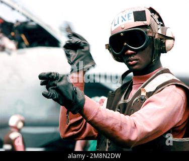 US Navy Plane Captain Airman right, instructs his trainee, Airman how ...