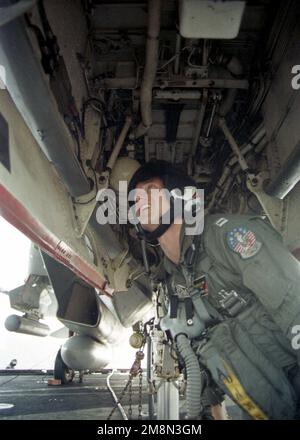 US Navy Lieutenant (LT) Chris Adams dons survival gear in preparation ...