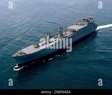 An aerial bow view of a Military Sealift Command ship and U.S. Navy ...