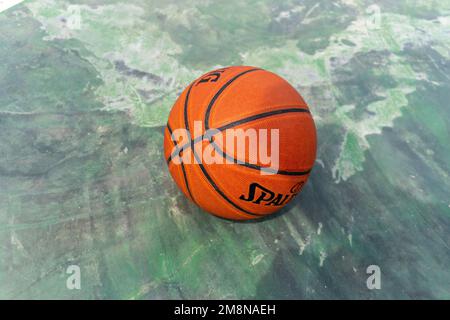 Orange basketball lying in the middle of the basketball court close up ...