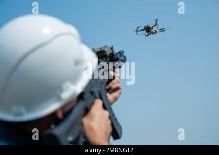 Caucasian man shoots a flying drone with a rifle Stock Photo - Alamy