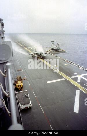 An AV-8B Harrier from HMM-266 lands on USS Wasp (LHD 1) flight deck ...