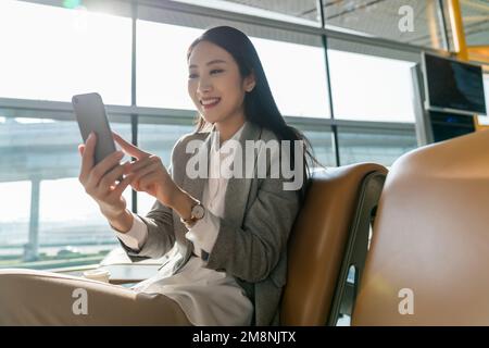 The use of mobile phones business lady in the airport lounge Stock ...