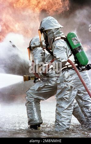 Two crash fire rescue Marines fight an extremely hot jet fuel fire to ...