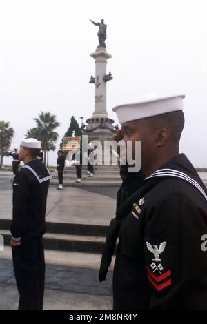US Navy A member of the Navy Honor Guard stands under a large American ...