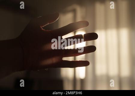 Abstract man hand playing with sunset light indoor, shallow focus Stock ...